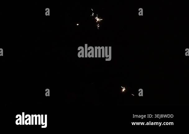 Sparks flying against a dark background, creating a dynamic visual ...