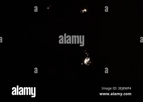 Sparks flying in dark background, creating a festive and dramatic ...