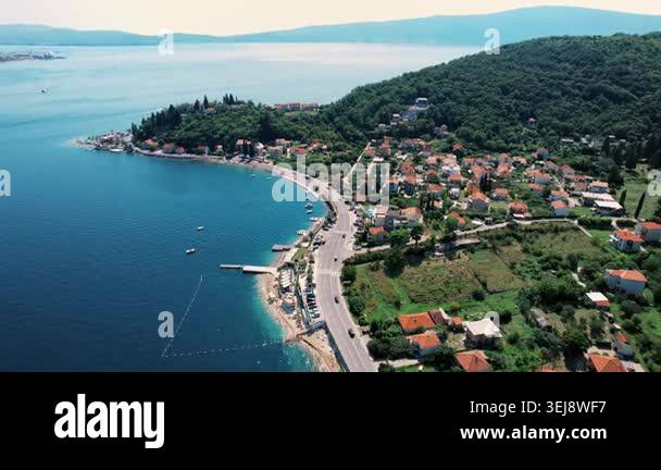 Winding coastal road along Montenegro shore, seaside village with red ...