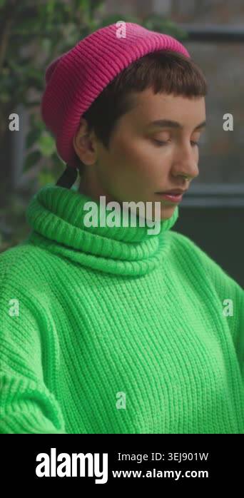young person in neon green sweater, quiet studio portrait, pensive ...