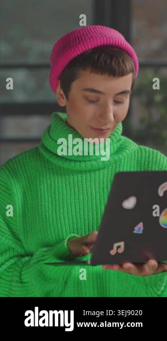 young person working on laptop, casual studio workspace, neon green ...