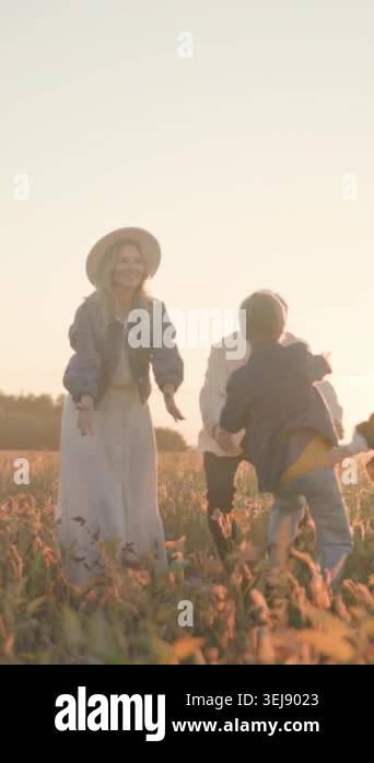 sunset meadow family white couple smiling with children near lone tree ...