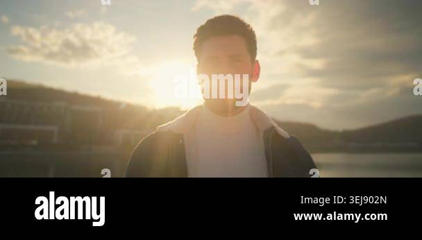 Caucasian man reflecting waterfront sunset, wearing turtleneck and ...