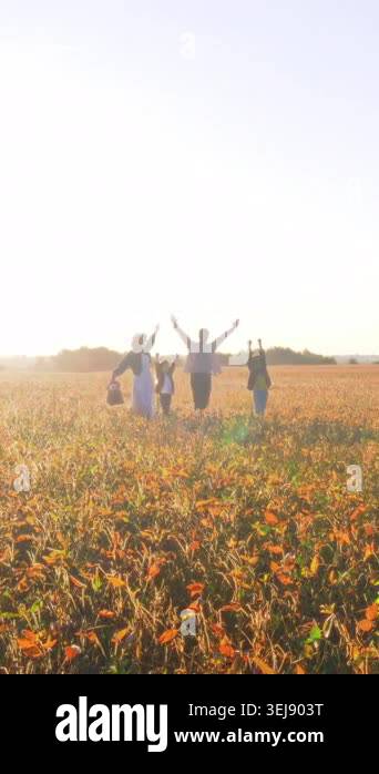 sunlit flower field with family celebrating among tall blooms, sun ...
