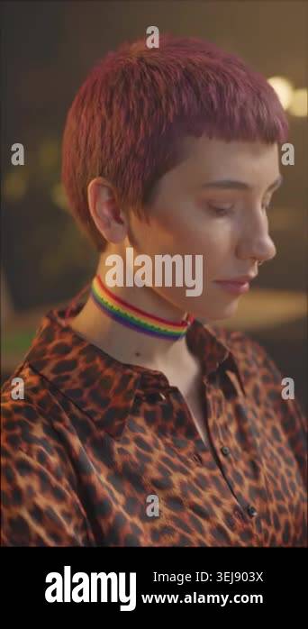 Shorthaired person smiling with rainbow choker, joyful candid portrait ...