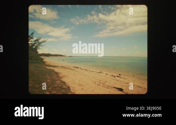 sandy shoreline with turquoise calm sea under blue sky and scattered ...