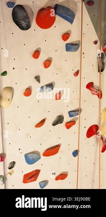 Indoor climbing wall with colorful holds full frame sport background ...