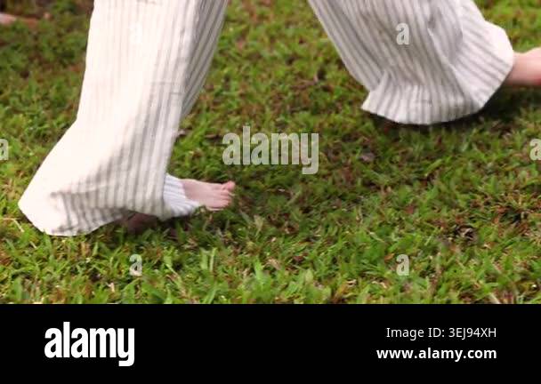 Barefoot walking on grass earth connection ecology lifestyle concept ...