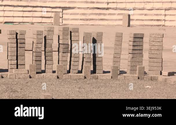 Urban road construction laying cement blocks forming street mosaic ...