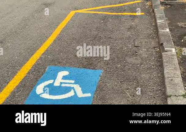 Parking space reserved for disability, marked by the traditional yellow ...