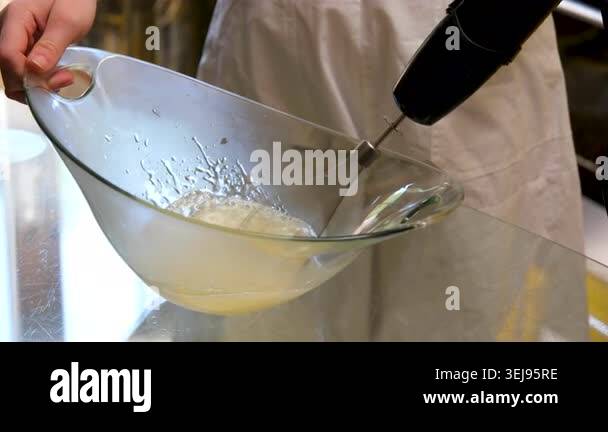 preparing the glaze for Easter from gelatin, whisk, heat hands woman in ...