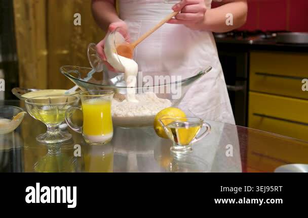 hands woman in white dress knead butter dough, adding sugar honey sour ...