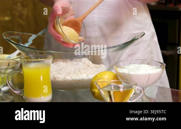 hands woman in white dress knead butter dough, adding sugar honey sour ...