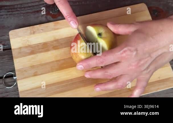 Juicy apple cut into pieces on wooden board during fresh fruit ...