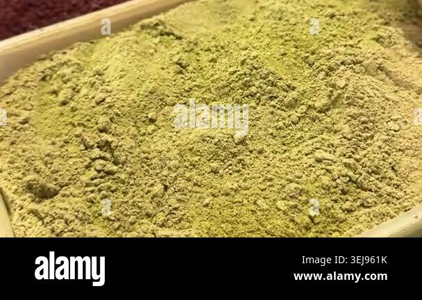 Crushed bay leaf spice powder stored in container with aromatic herbal ...