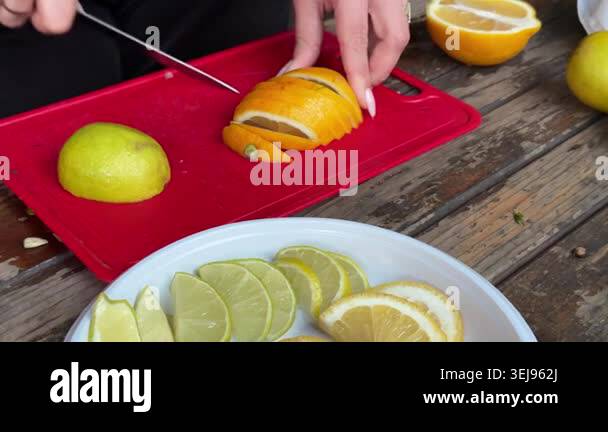 Bright citrus composition with woman cutting orange into slices beside ...
