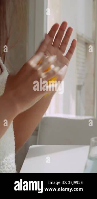 Playful morning routine scene, woman in towel laughing and squeezing ...
