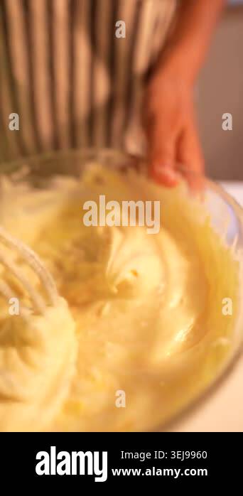 Closeup hands cracking egg over bowl, striped apron, golden yolk ...
