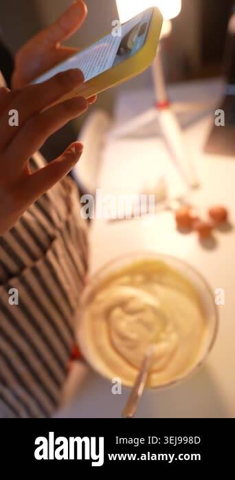 Home kitchen caucasian woman reading recipe on smartphone while ...