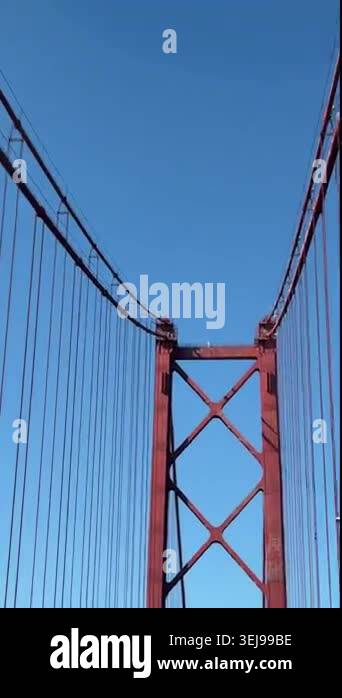 Central bridge tower framed by sky, vertical cables and precise ...