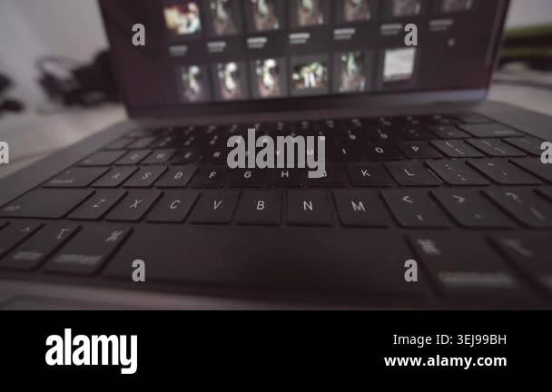 Angled close up laptop keyboard with thumbnails, fast camera tilt ...