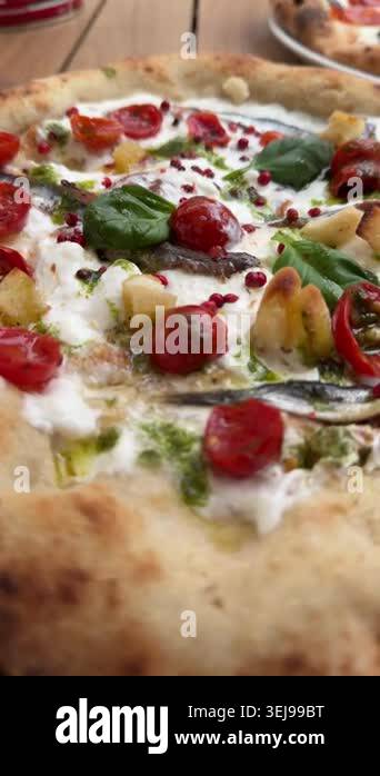 Closeup burrata pizza with cherry tomatoes and basil, missing slice on ...