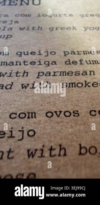 Closeup printed menu text on kraft showing bilingual lines and ...