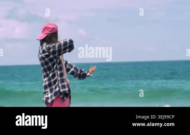 Young lady with camera enjoying seaside scenery. Teenage woman smiling ...