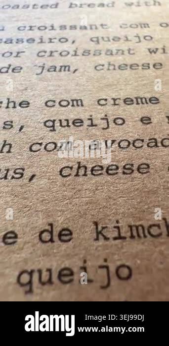 Closeup bilingual kraft menu lines with typewriter ink and breakfast ...