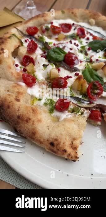 Plate burrata pizza on wooden table with wine glass rim and fork ...