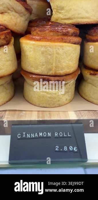 Rich chocolate swirls on artisan buns in glass case, marbled loaves and ...