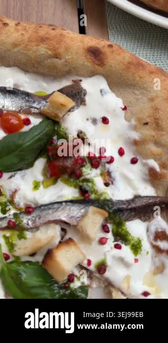 Closeup burrata pizza with anchovy and cherry tomatoes, creamy cheese ...