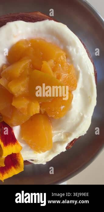 Overhead latte and peach pastry on plate, barista served cappuccino ...