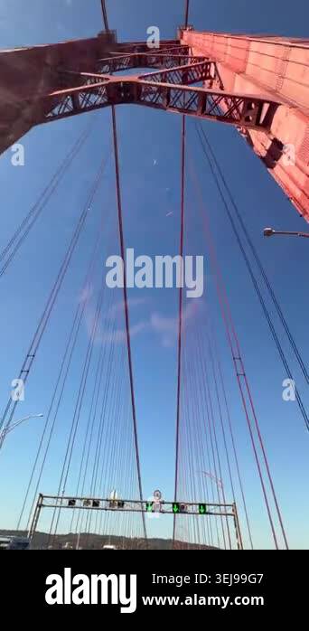 Red suspension cables stretching into sky, dramatic vertical lines and ...