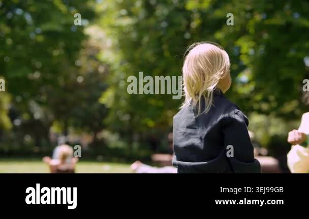 White toddler playing while woman photographs, blonde child giggling ...