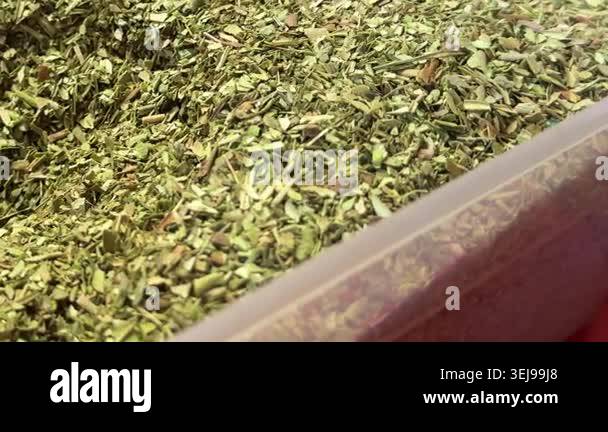 Organic oregano flakes stored in spice container with rich herbal aroma ...