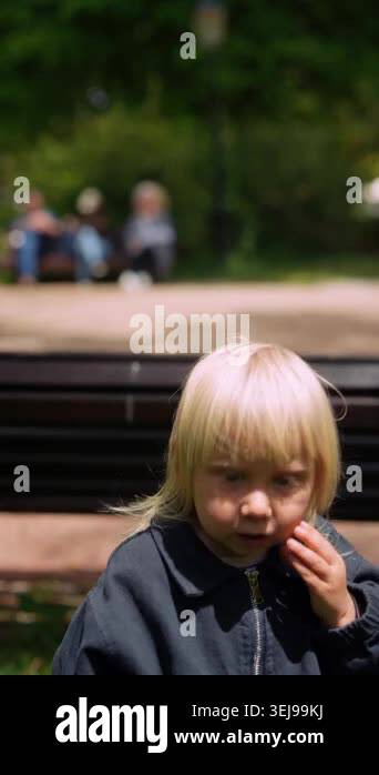 White toddler examining branch leaves close, inspecting veins and ...