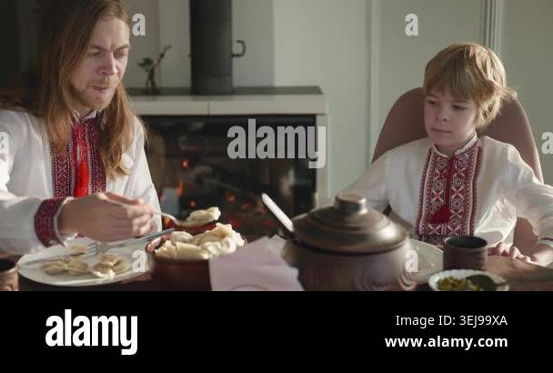 Man With Kid Boy Eat Food Lunch Dinner. Family in Ukrainian Traditional ...