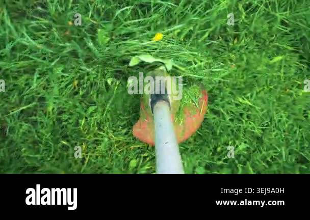 mowing grass and weeds outdoors in sunny, warm weather from the first ...