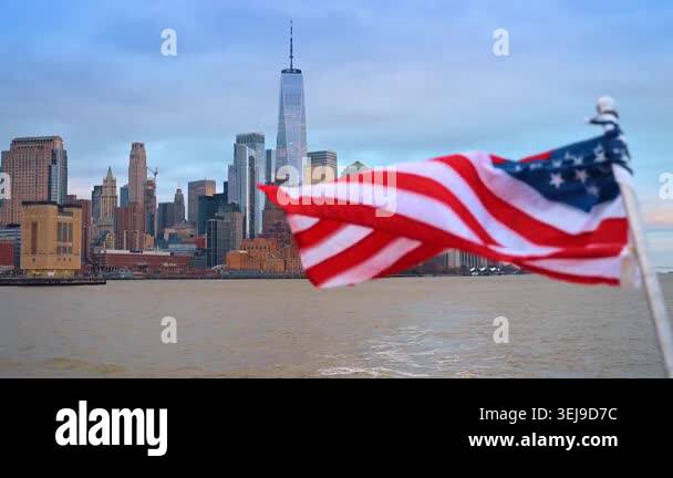 Boat travel with American flag on board. Dense Manhattan skyline in the ...