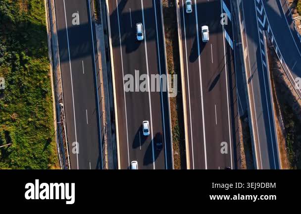 Top down view of highway lanes with traffic and shadows. Direct ...