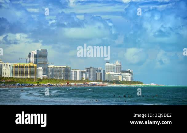 Surfers float on the waterscape waiting for the proper waves. Miami ...