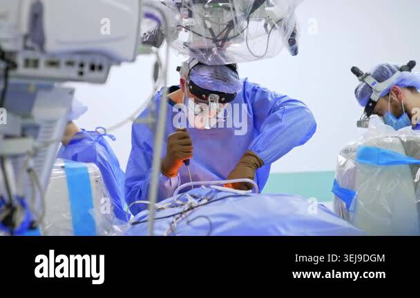 Professional neurosurgeon carries out the surgery. Doctor looks through ...
