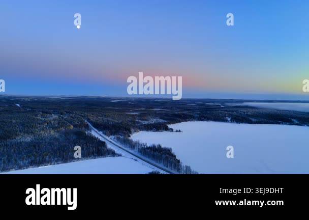 Vast fields covered with snow and pine tree forests. Approaching the ...