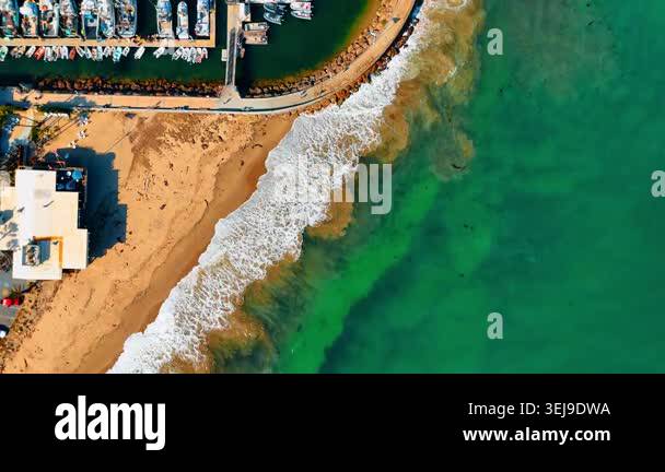 Turquoise ocean rolling foamy waves to the sandy beach. Drone footage ...