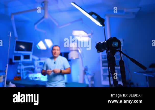 Male surgeon talks to camera in the surgery room. Doctor creates a ...
