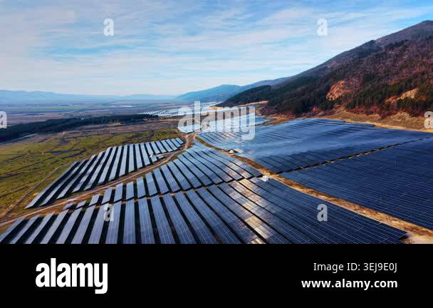 Glowing modern solar panels in the long rows. Drone footage over the ...