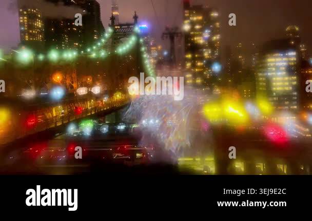 Blurred image of city lights sparkling at night through the window ...