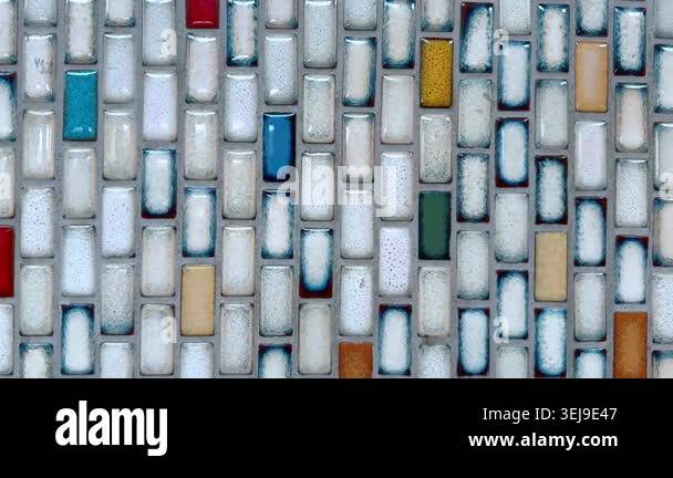 Wall of tiled pieces of diverse colors. Decor concept. Ceramic mosaics ...