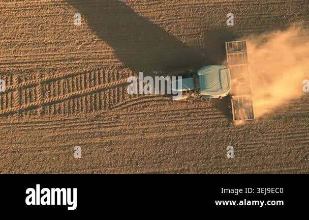 Aerial View of Tractor Plowing Brown Soil in Agricultural Field ...